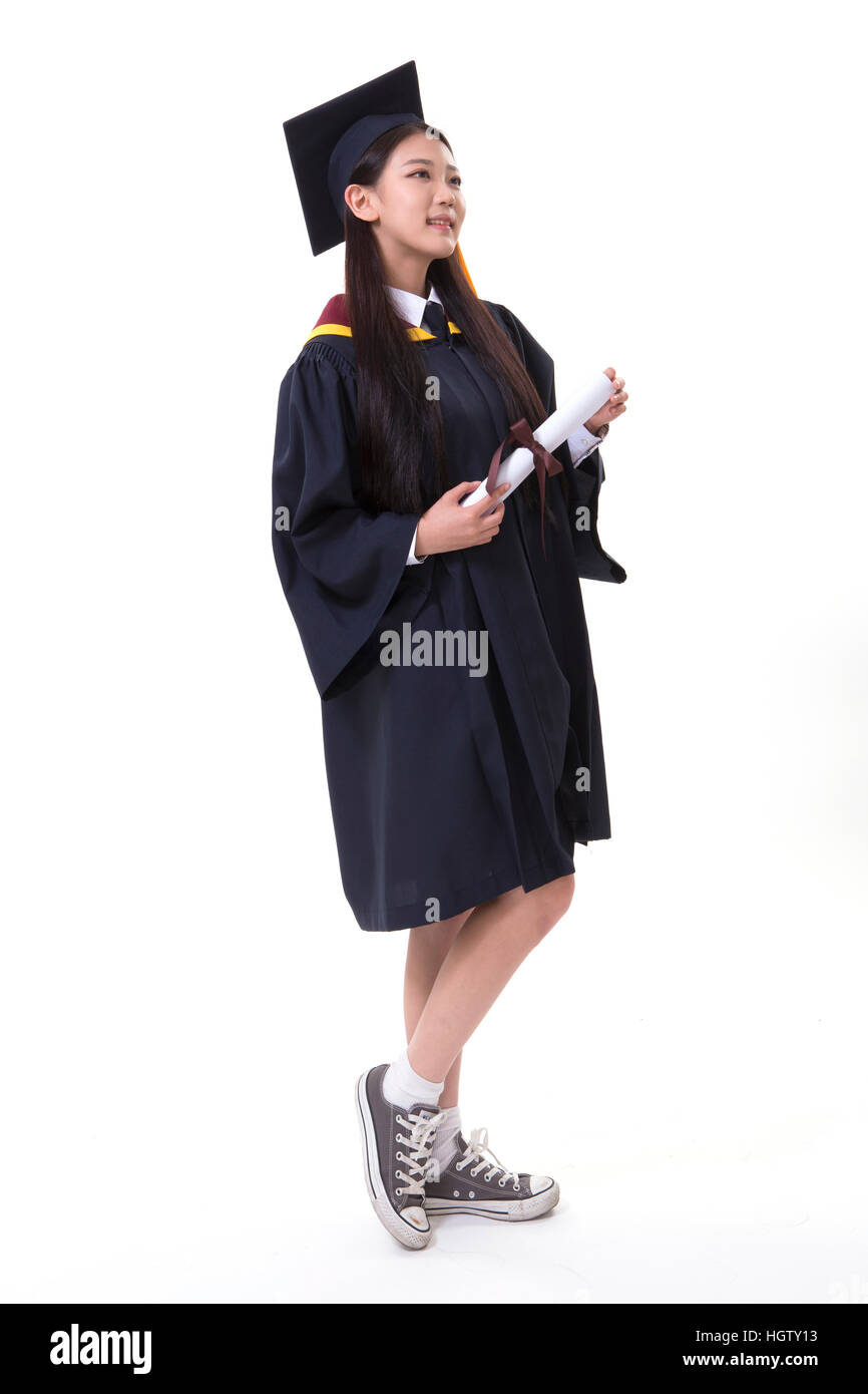 Side view of smiling female graduate walking Stock Photo - Alamy