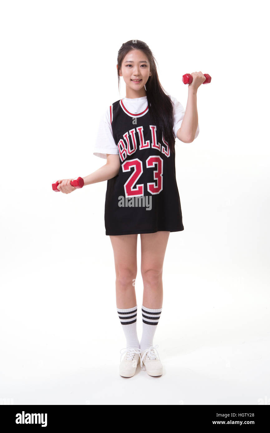 Young smiling Korean woman exercising with dumbbells Stock Photo - Alamy