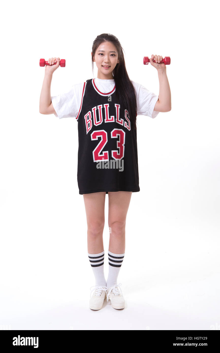 Young smiling Korean woman exercising with dumbbells Stock Photo - Alamy