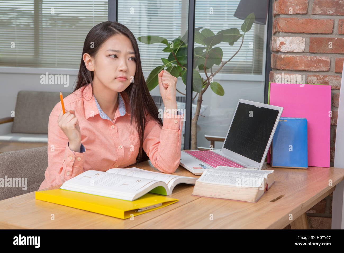 Portrait of young determined woman Stock Photo - Alamy