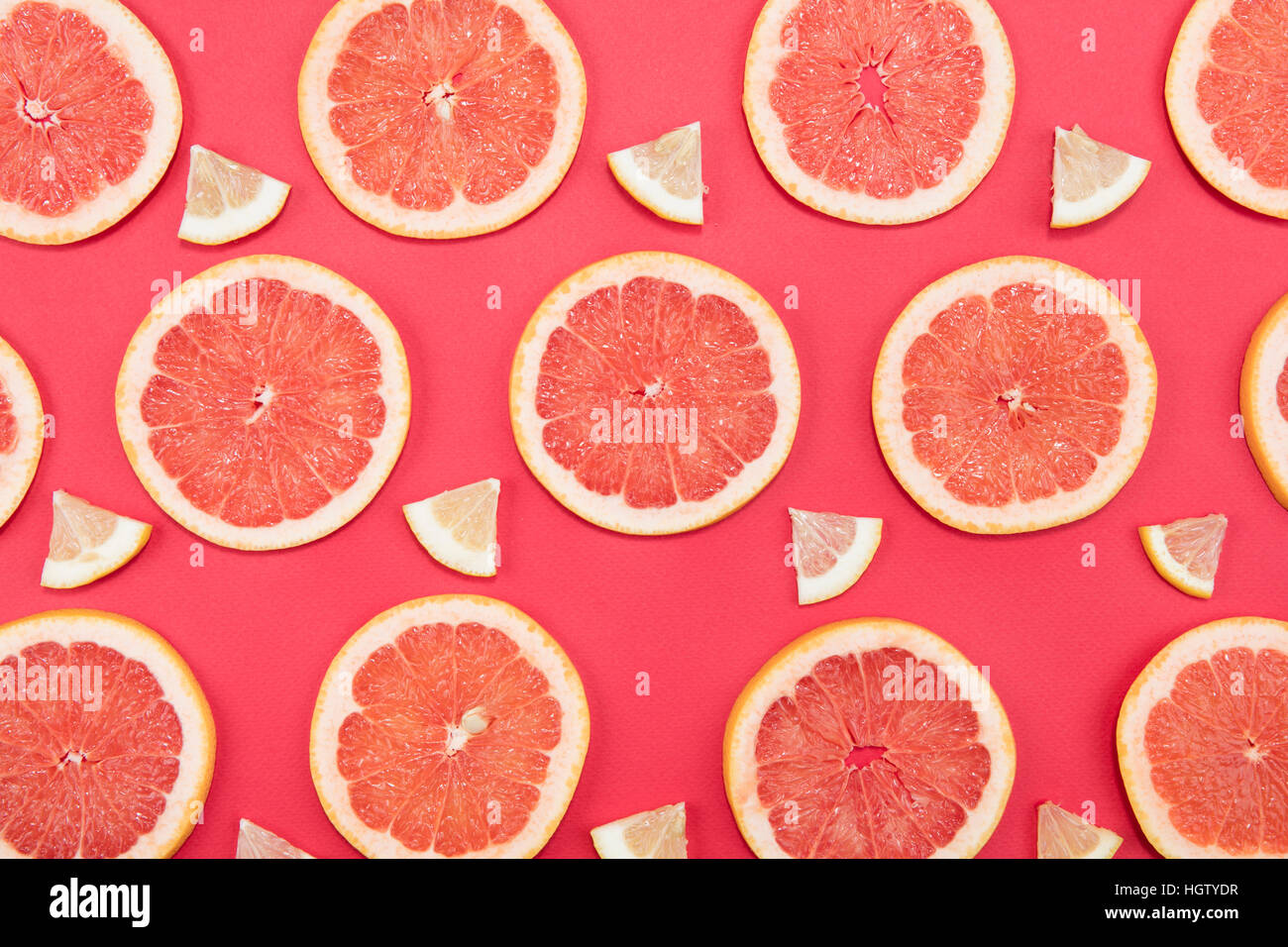 Cross sections of grapefruit against orange background Stock Photo - Alamy