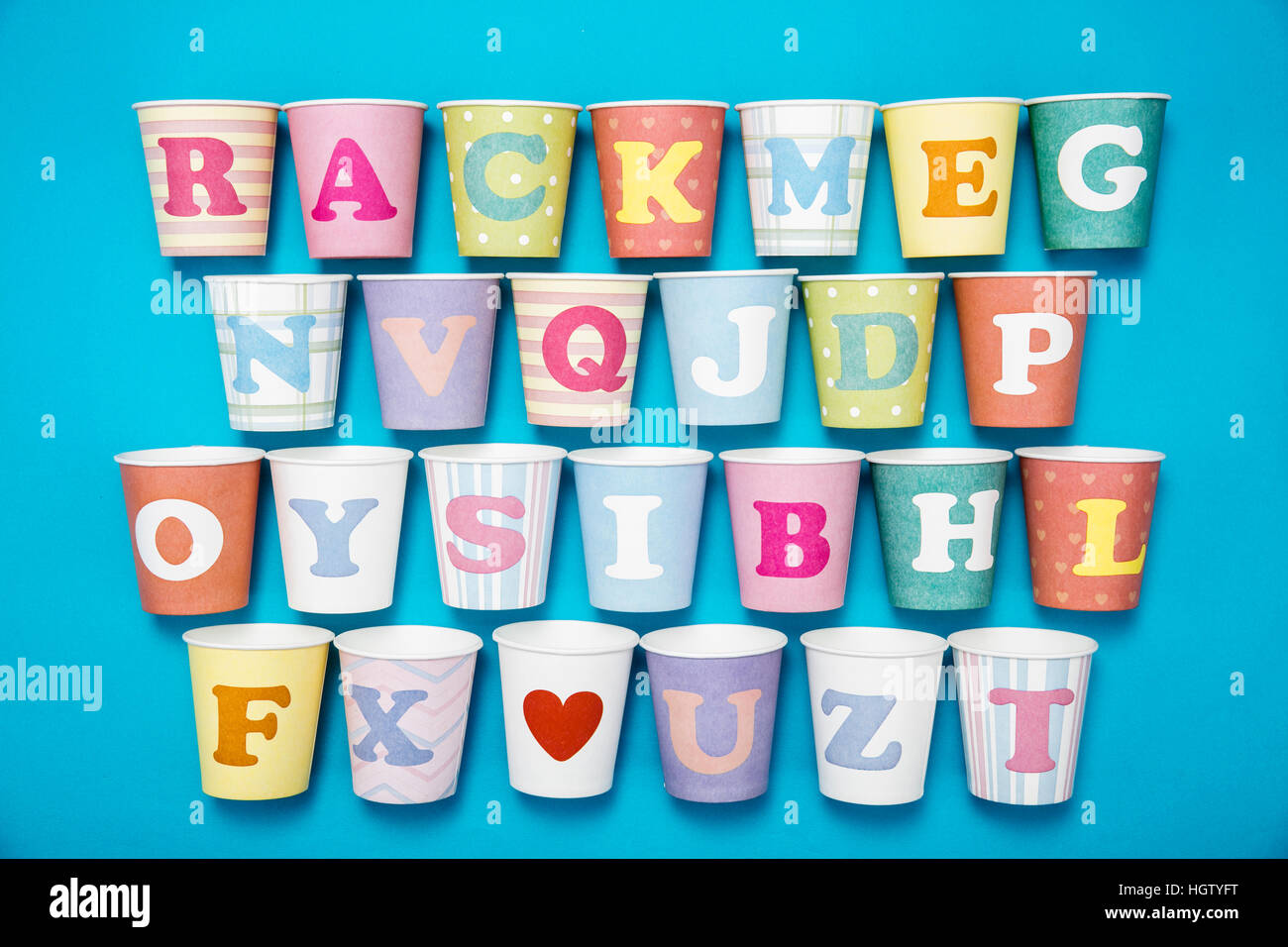 Background with lots of paper cups of alphabet letters Stock Photo - Alamy