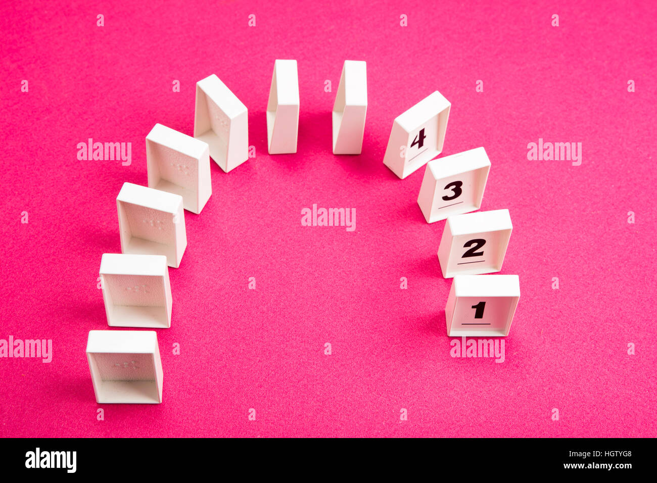 Dominoes with numbers standing Stock Photo - Alamy