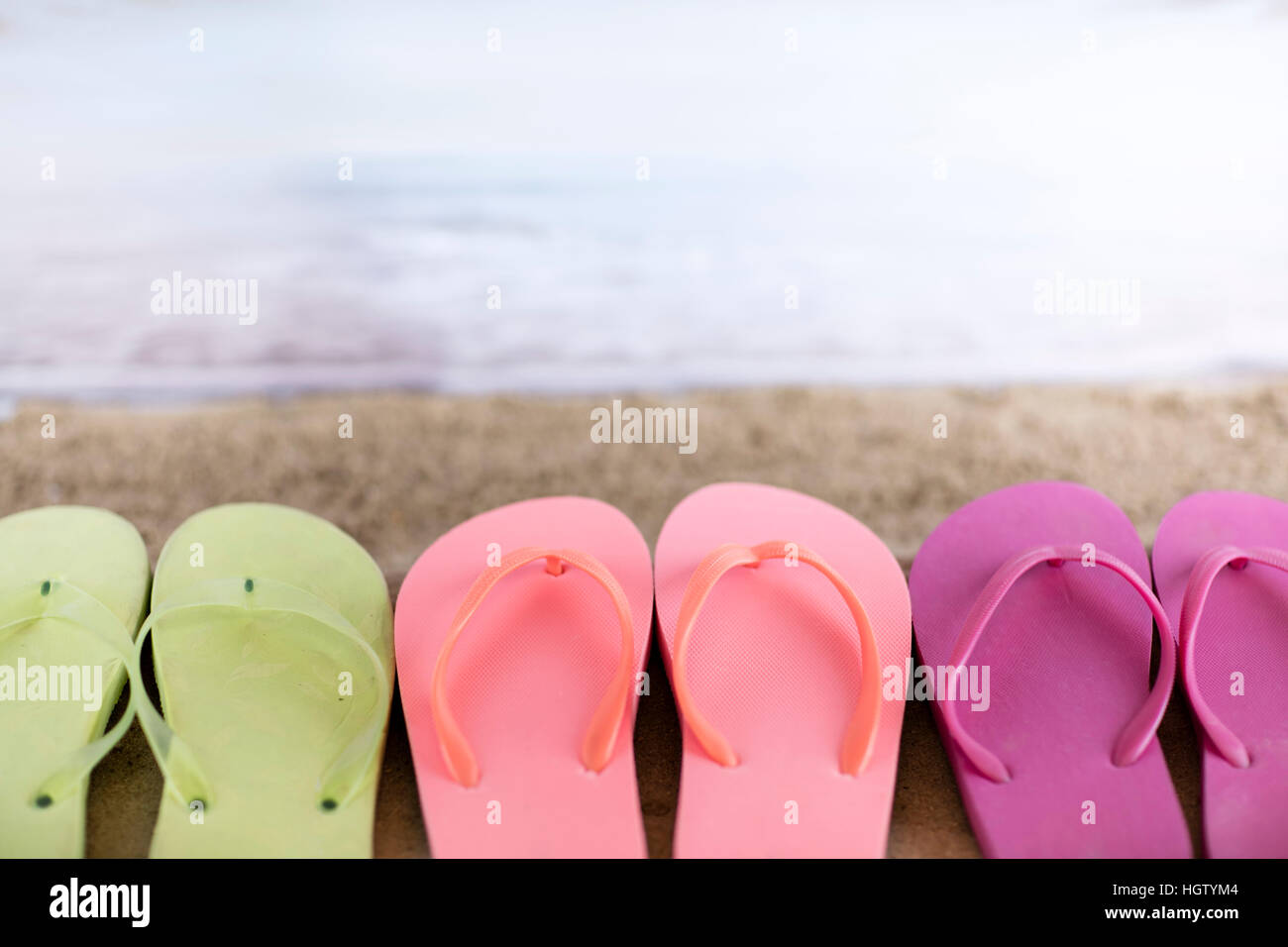 Flip-flaps on beach representing summer vacation Stock Photo - Alamy