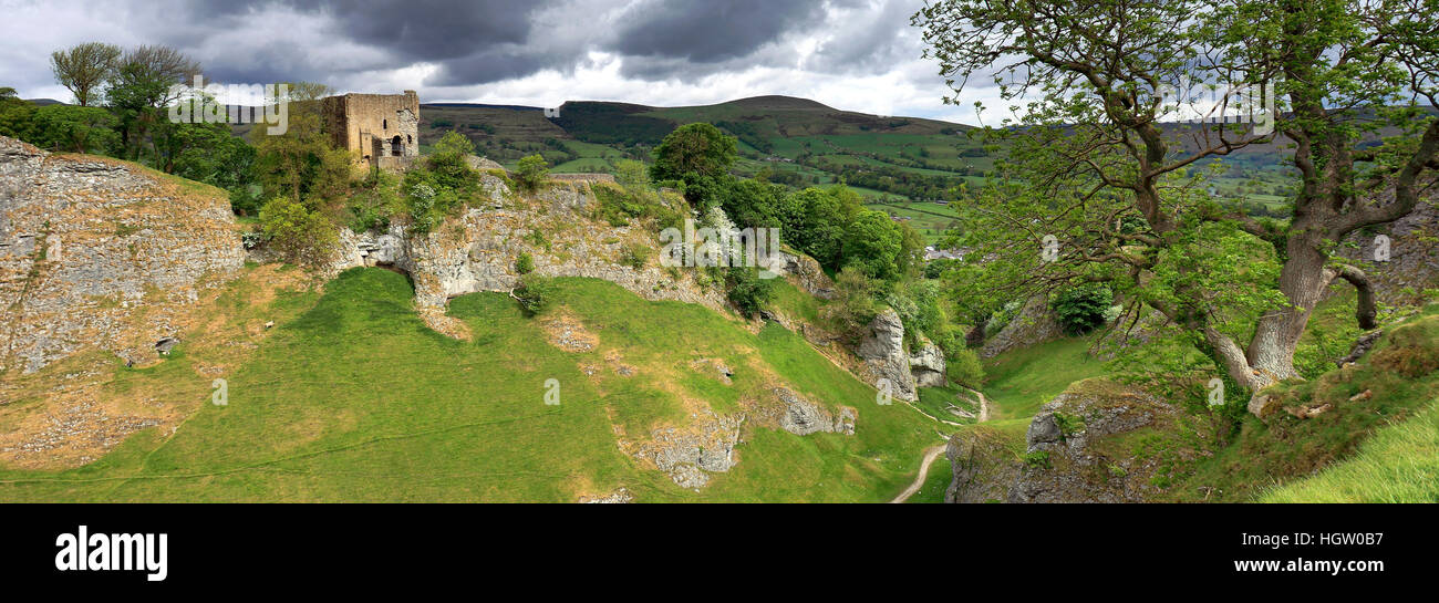 Summer view through Cave Dale with the ruins of Peveril Castle ...