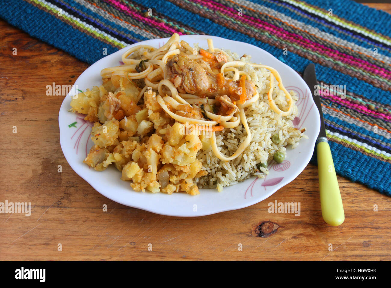 Plate of rice, potatoes, noodles and chicken, typical Peruvian Sierra ...