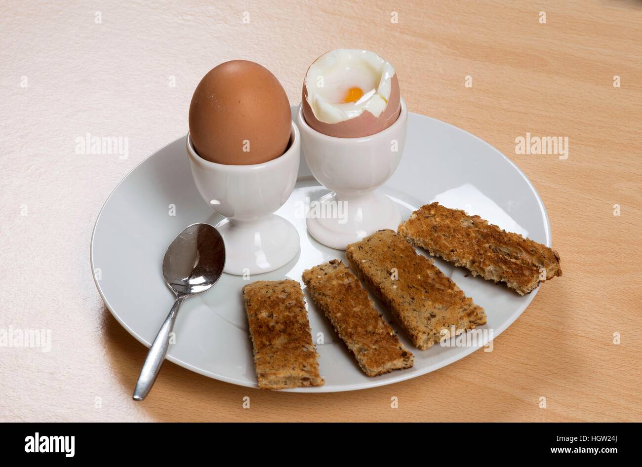 Breakfast of boiled eggs and soldiers on a plate Stock Photo - Alamy
