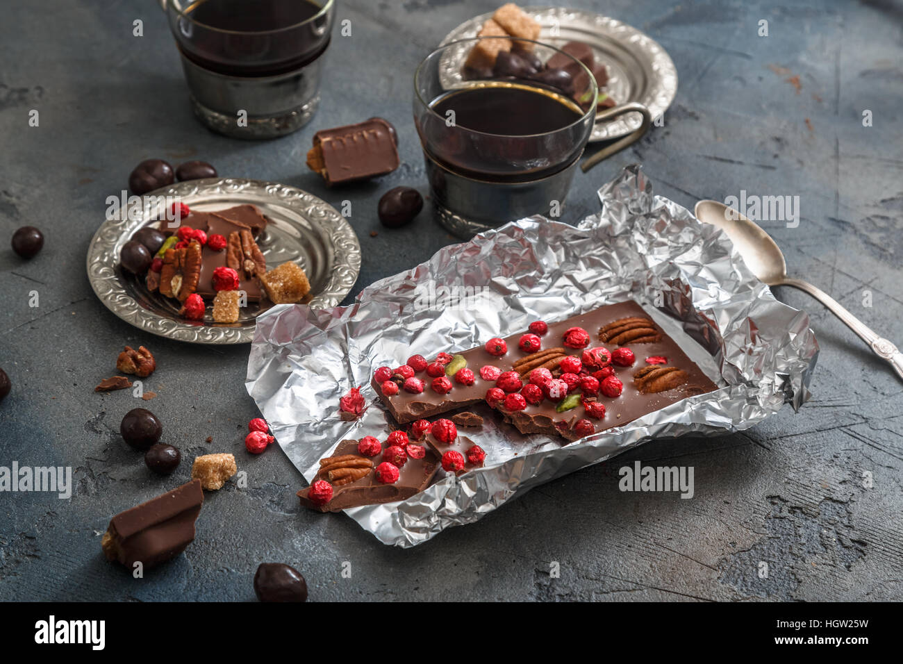 coffee in vintage silver cups on a dark background with chocolate ...
