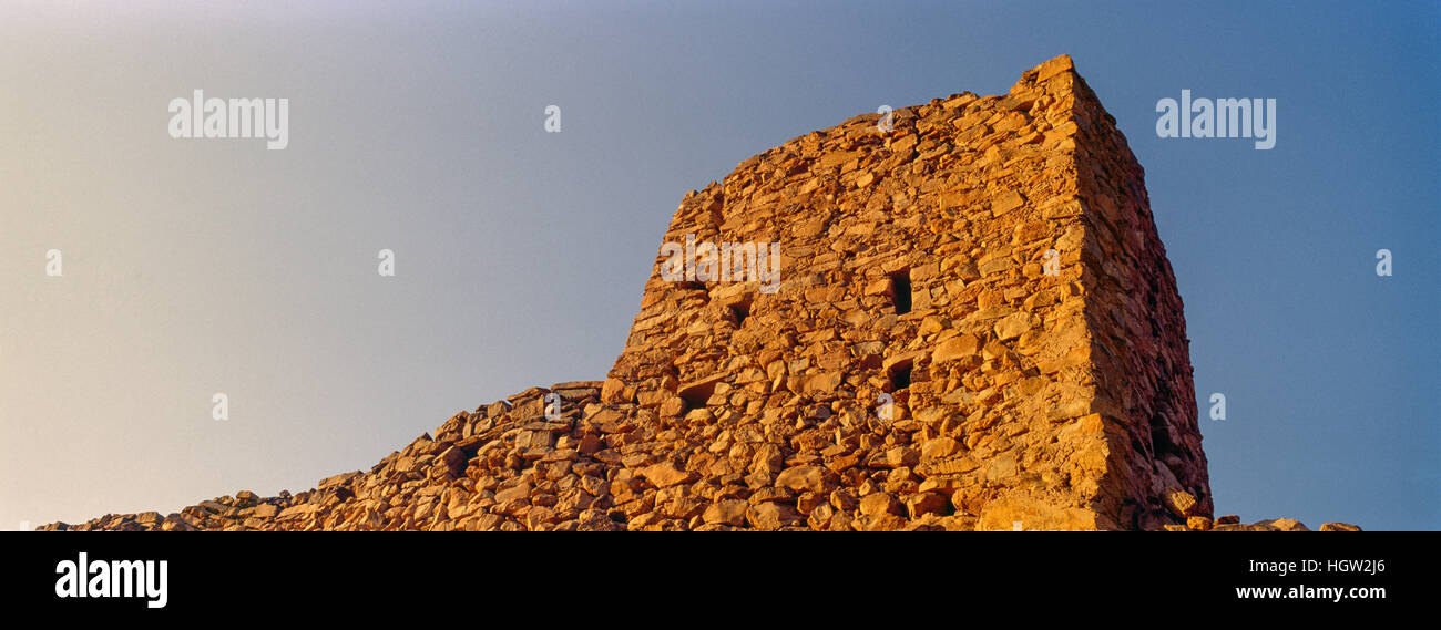 An ancient handmade stone watchtower in an abandoned mountain desert ...