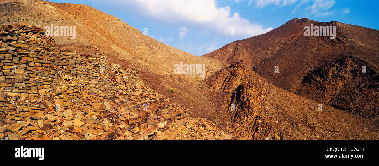 Ancient handmade stone burial mounds and tombs atop a desert ridge ...