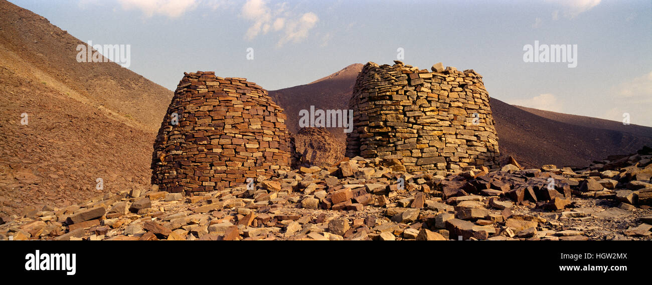 Ancient handmade stone burial mounds and tombs atop a desert ridge ...