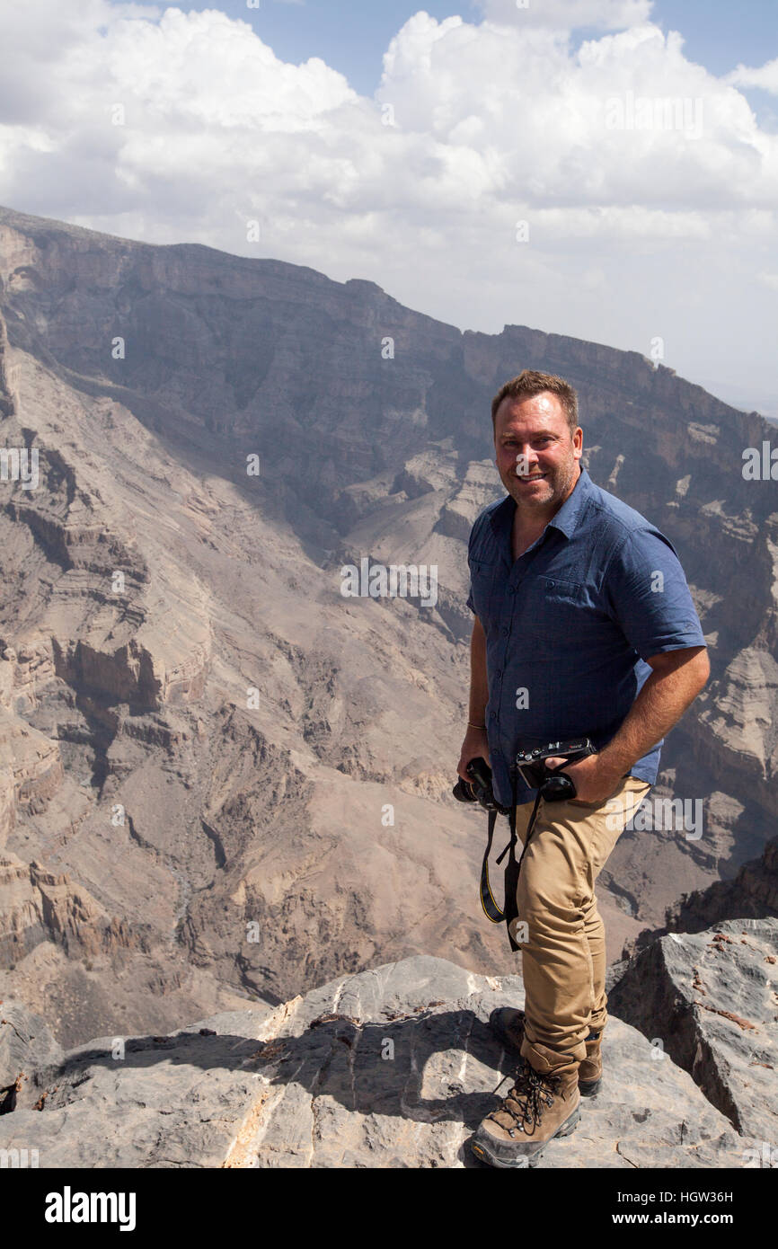 Photographer Jason Edwards standing on the rim of an enormous canyon ...