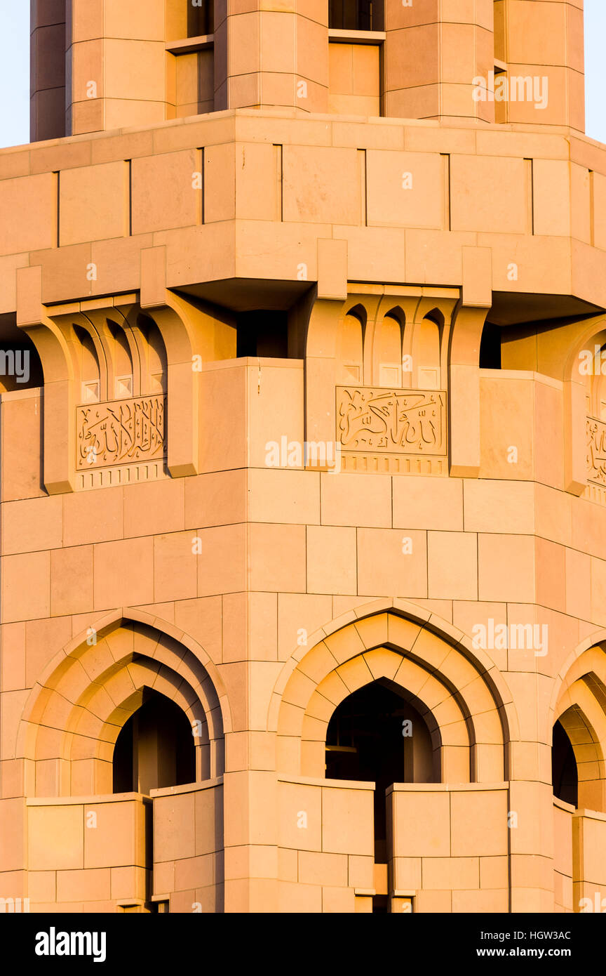 A balcony on an ornate stone minaret that towers over the dome of the ...
