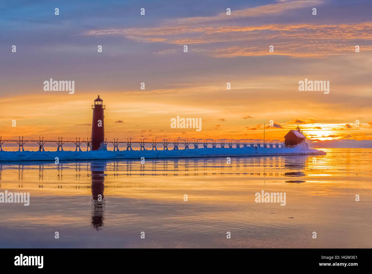 Grand Haven Lighthouse at sunset, at the mouth of the Grand River where ...