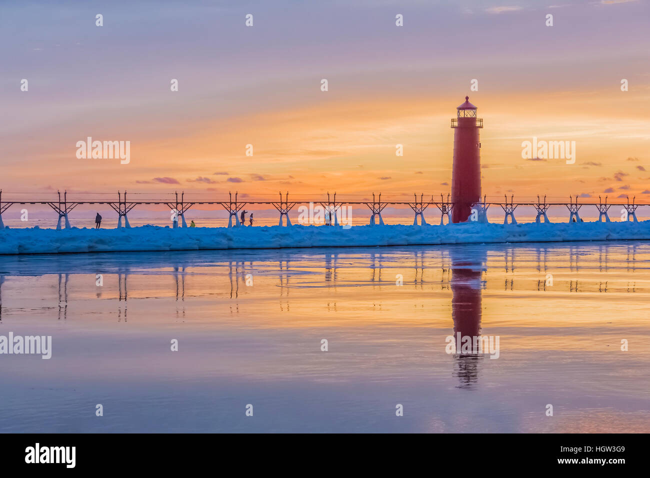 Grand Haven Lighthouse at sunset, at the mouth of the Grand River where ...