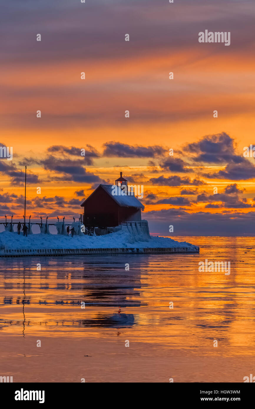 Grand Haven Lighthouse at sunset, at the mouth of the Grand River where ...