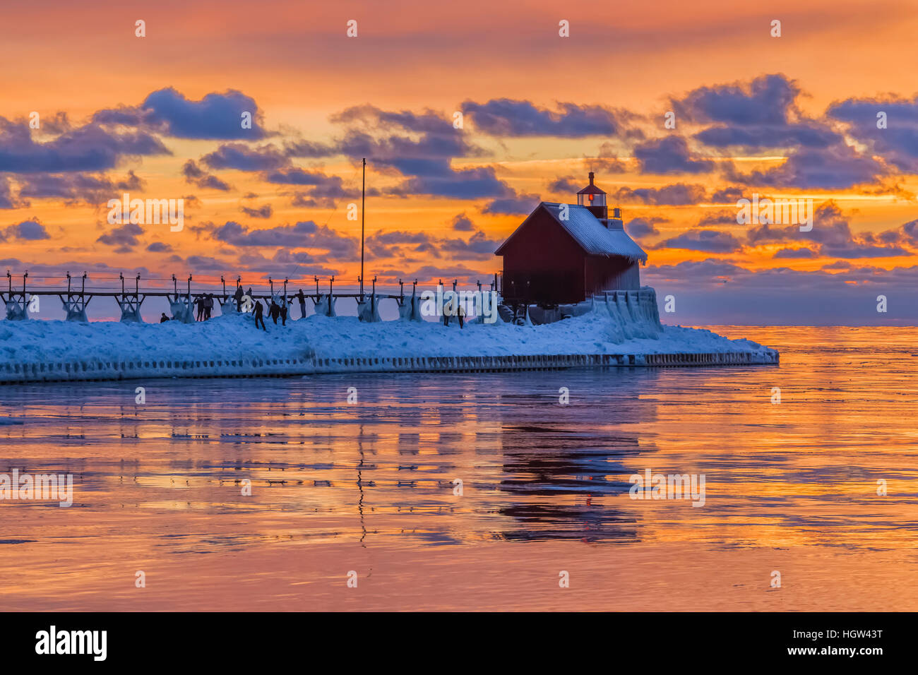 Grand Haven Lighthouse at sunset, at the mouth of the Grand River where ...