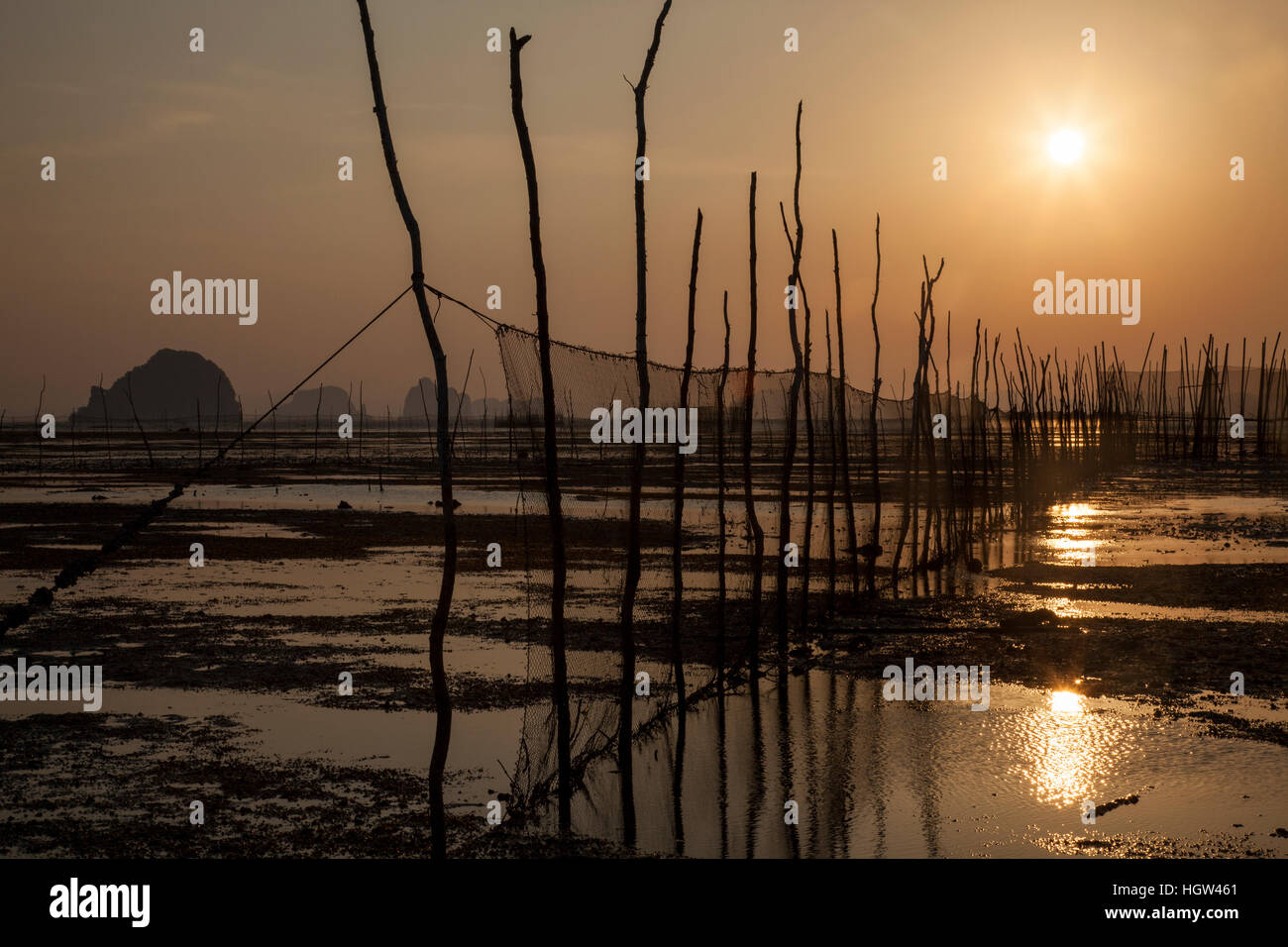 Tide fishing nets at sunset. Thailand Stock Photo - Alamy