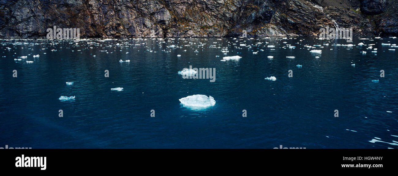 Crushed ice from a glacier fall floating on the ocean surface in a ...