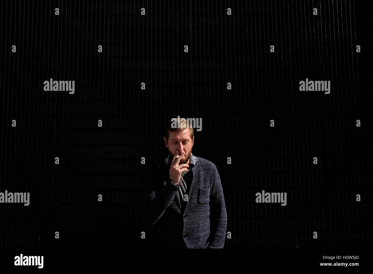Man smoking in shadows hi-res stock photography and images - Alamy