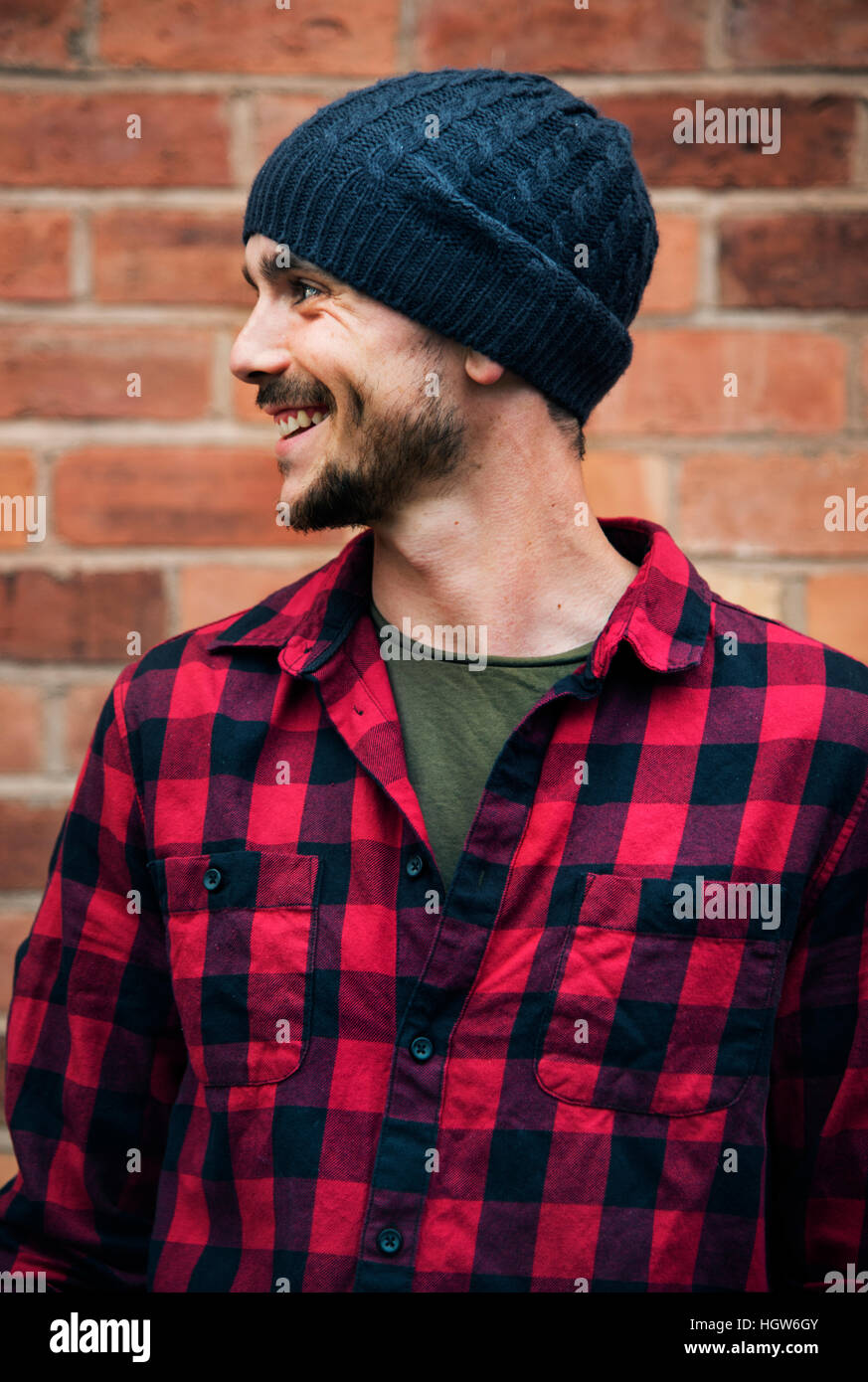 Man Beanie Hat Hipster Style Brick Wall Smiling Concept Stock Photo - Alamy