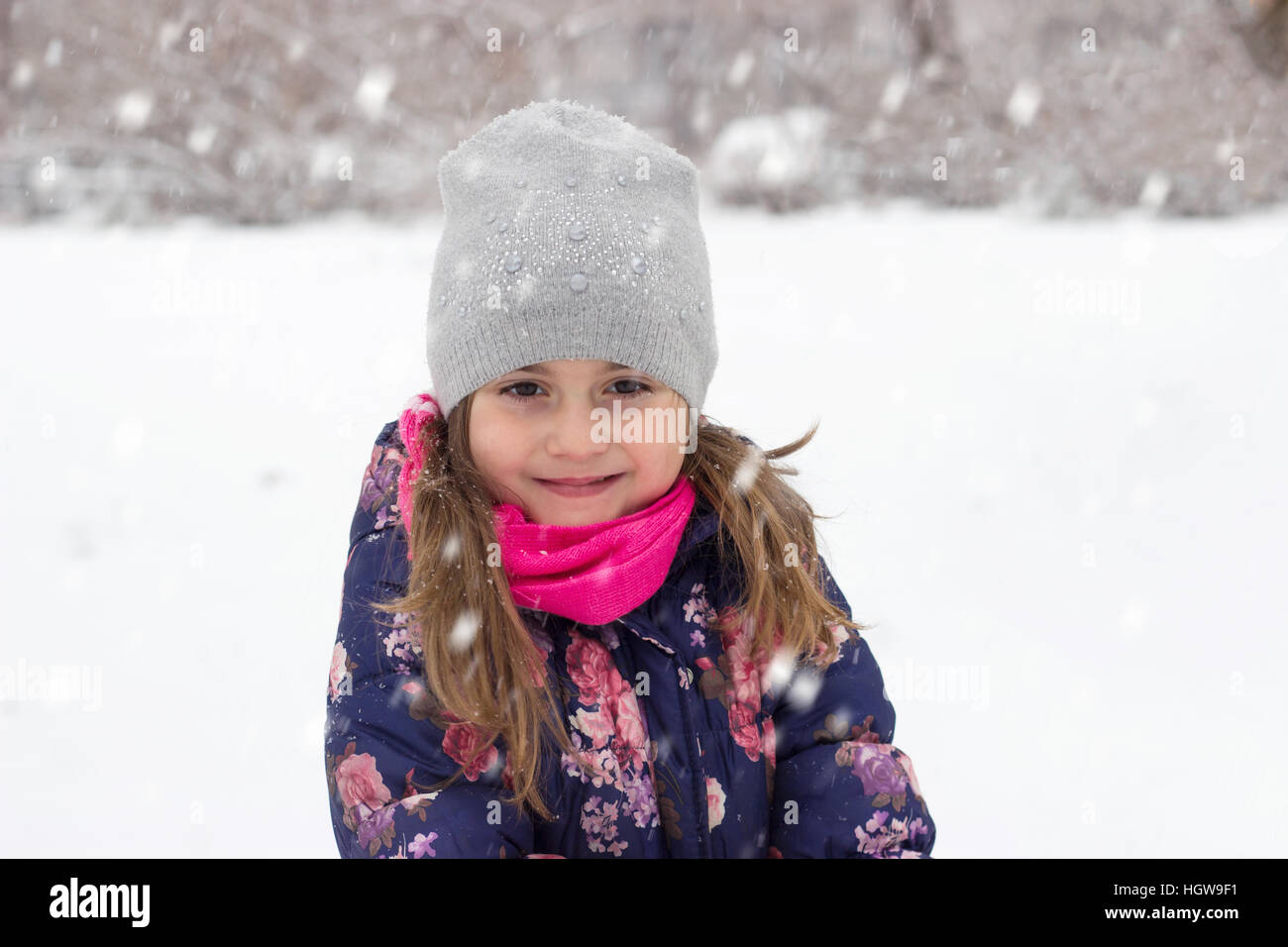 Little girl on the snow Stock Photo - Alamy