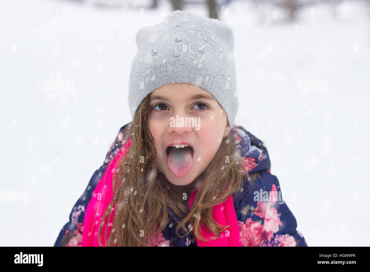 Little girl eating snow Stock Photo - Alamy
