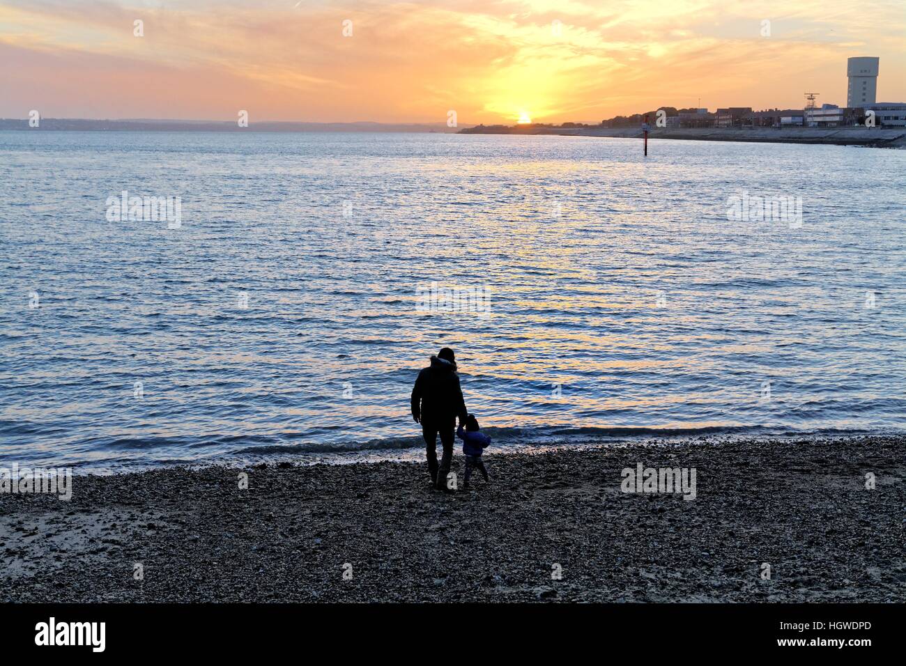 Father and son on beach at sunset Stock Photo - Alamy