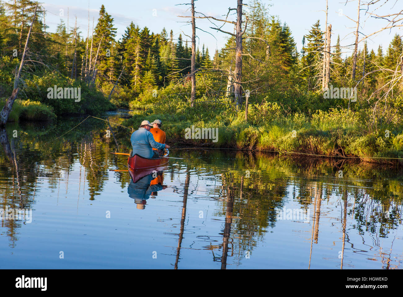 Two men fly-fishing for brook trout from a canoe on the Cold Stream ...