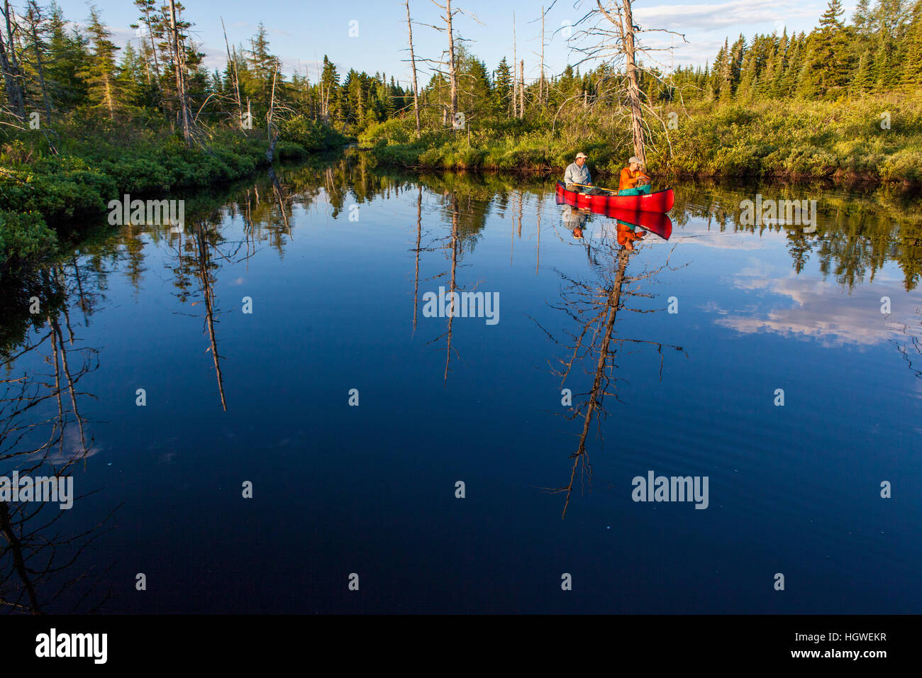 Two men fly-fishing for brook trout from a canoe on the Cold Stream ...