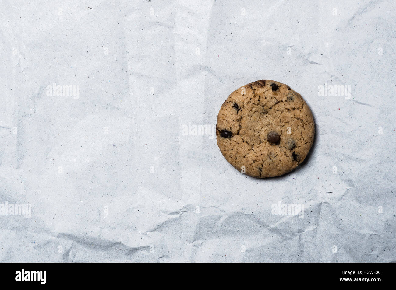 Macro shot of a danish cookie with chocolate drops over a white ...