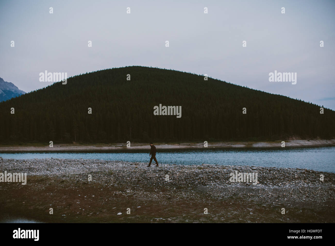 man walking beside river Stock Photo - Alamy