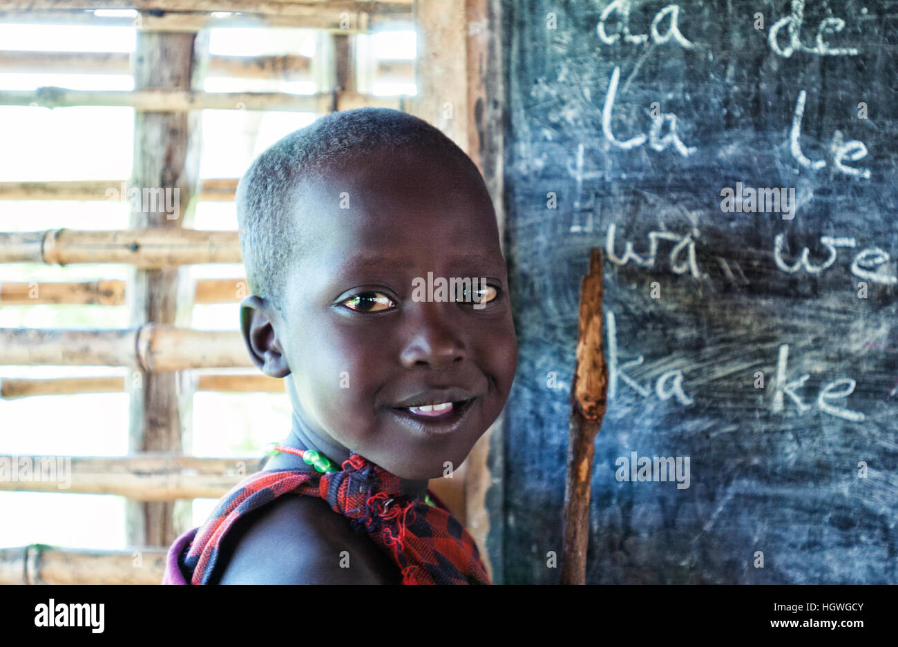 Young African Maasai boy by blackboard at school Stock Photo - Alamy