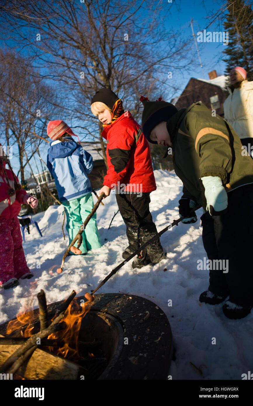 Kids roast mini hot dogs over a fire in a backyard in Portsmouth, New ...
