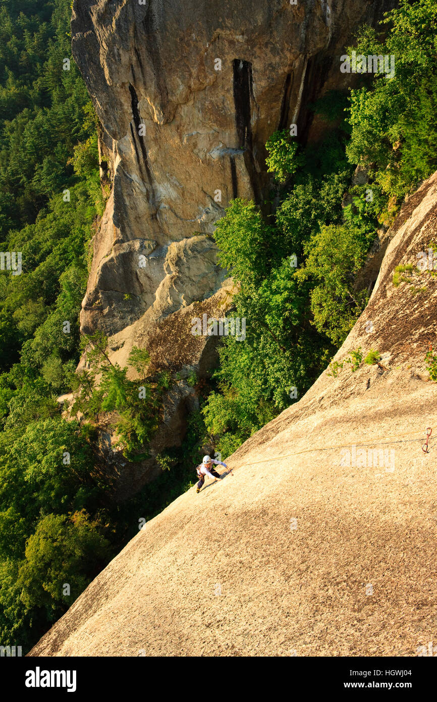 A woman rock climbing near the top of Cathedral Ledge. Echo Lake State ...