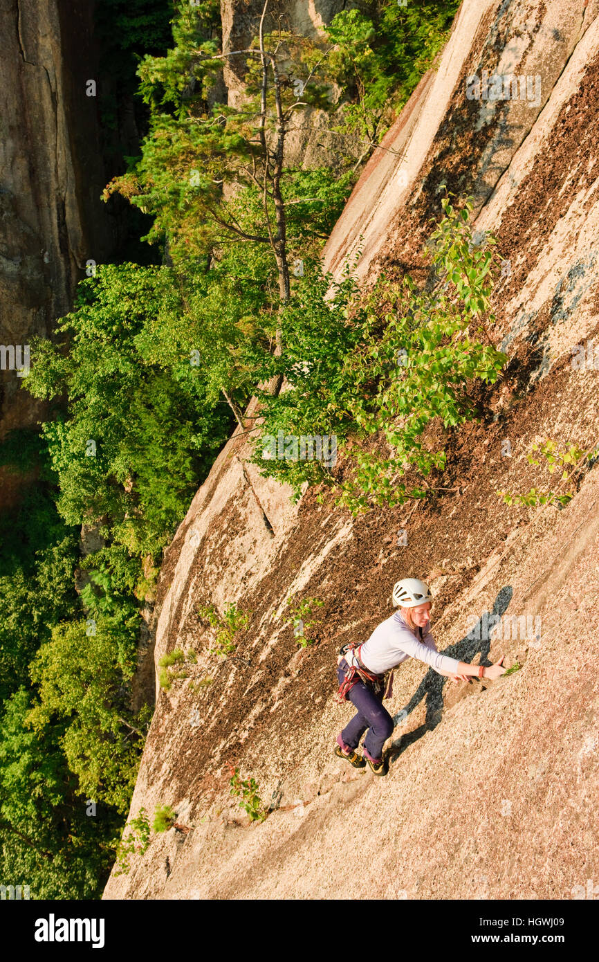 A woman rock climbing near the top of Cathedral Ledge. Echo Lake State ...