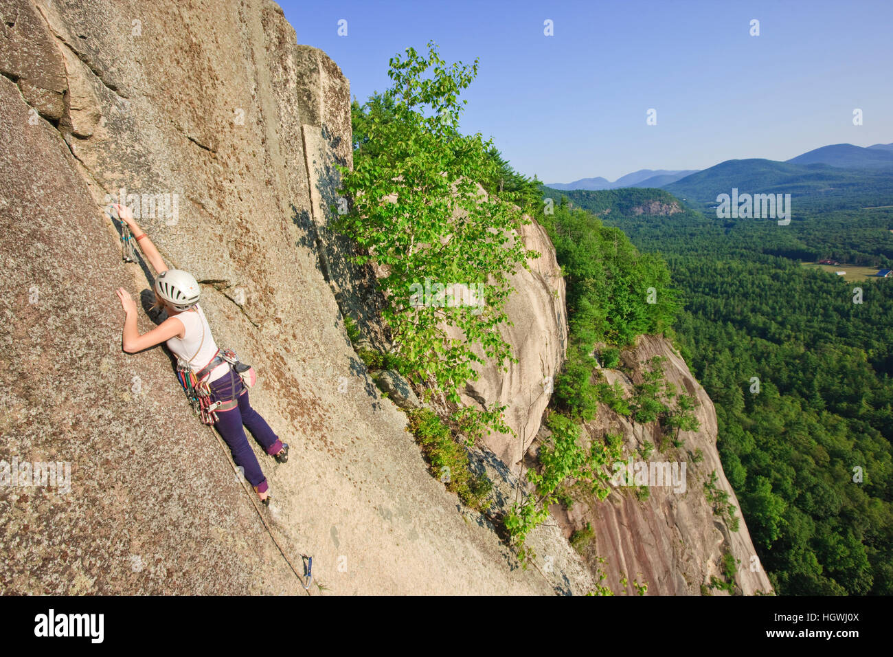 A woman leads a climb of "Top of the Prow" on Cathedral Ledge. Echo ...