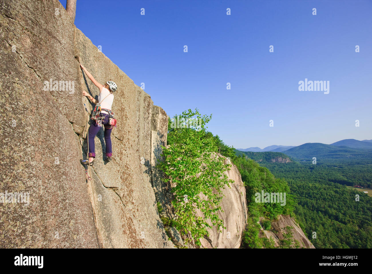 A woman leads a climb of "Top of the Prow" on Cathedral Ledge. Echo ...
