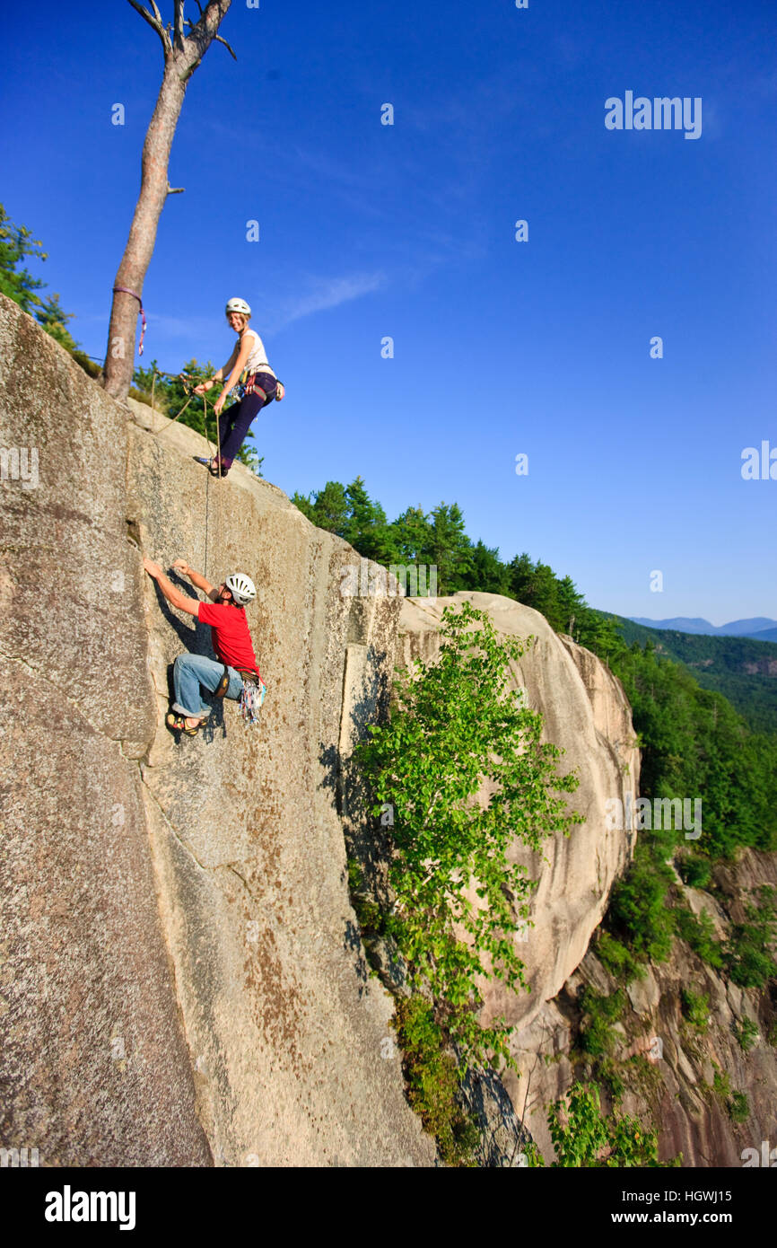 A man climbs "Top of the Prow" on Cathedral Ledge. Echo Lake State Park ...