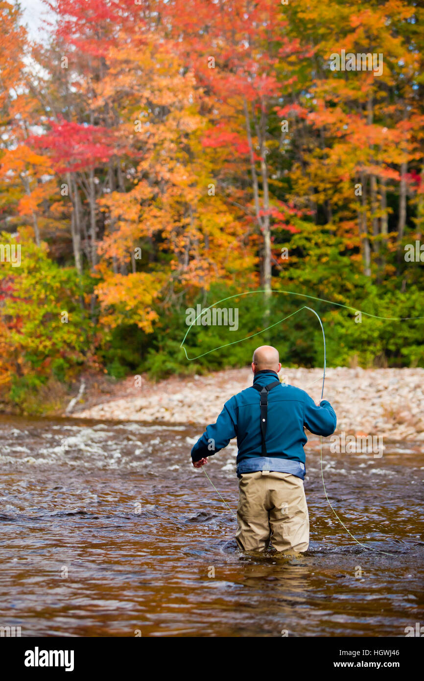 A man fly-fishing on the Swift River in Albany, New Hampshire. White ...