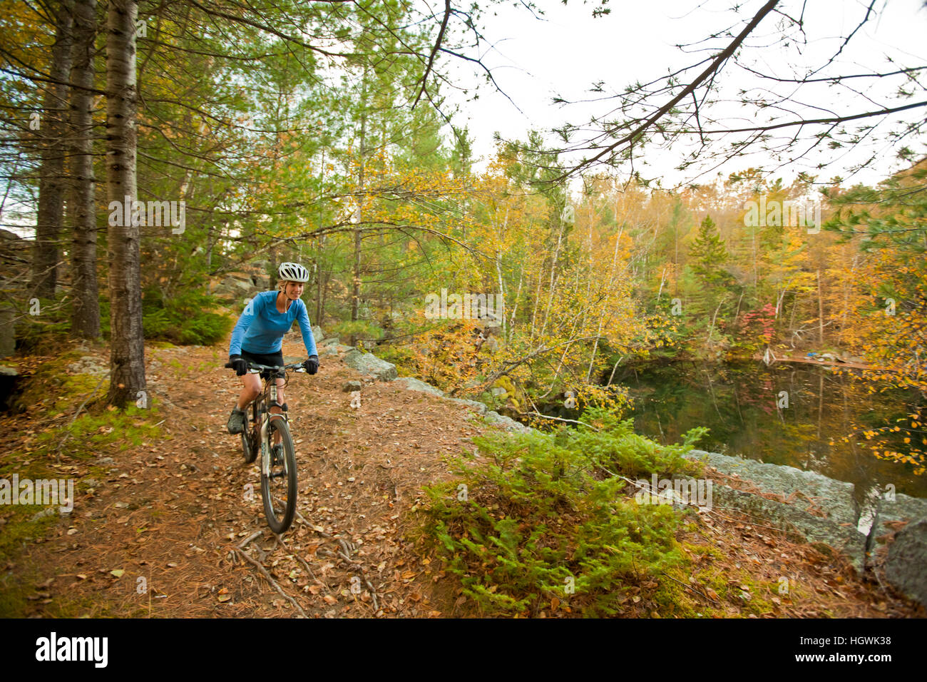 A woman mountain biking on a trail on Millstone Hill in Barre, Vermont ...