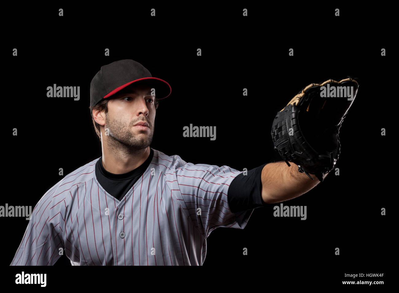 Baseball Player catching a ball on a black background. Studio Shot ...
