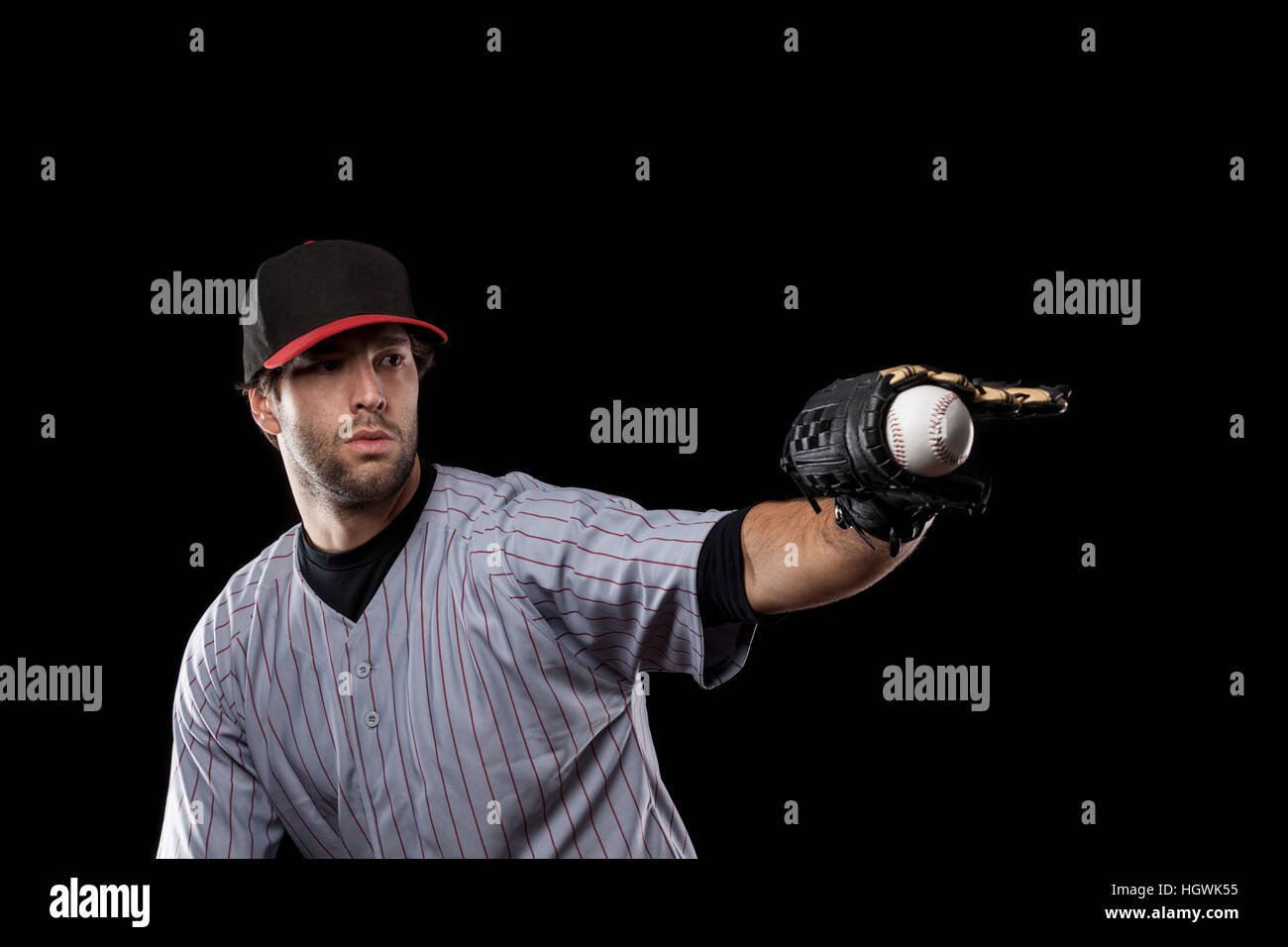 Baseball Player catching a ball on a black background. Studio Shot ...
