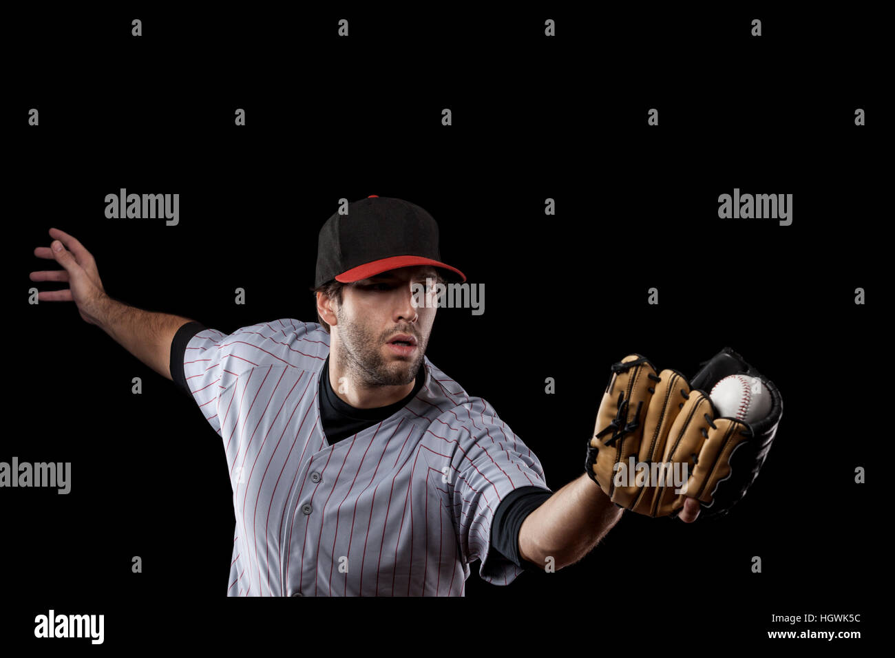 Baseball Player catching a ball on a black background. Studio Shot ...