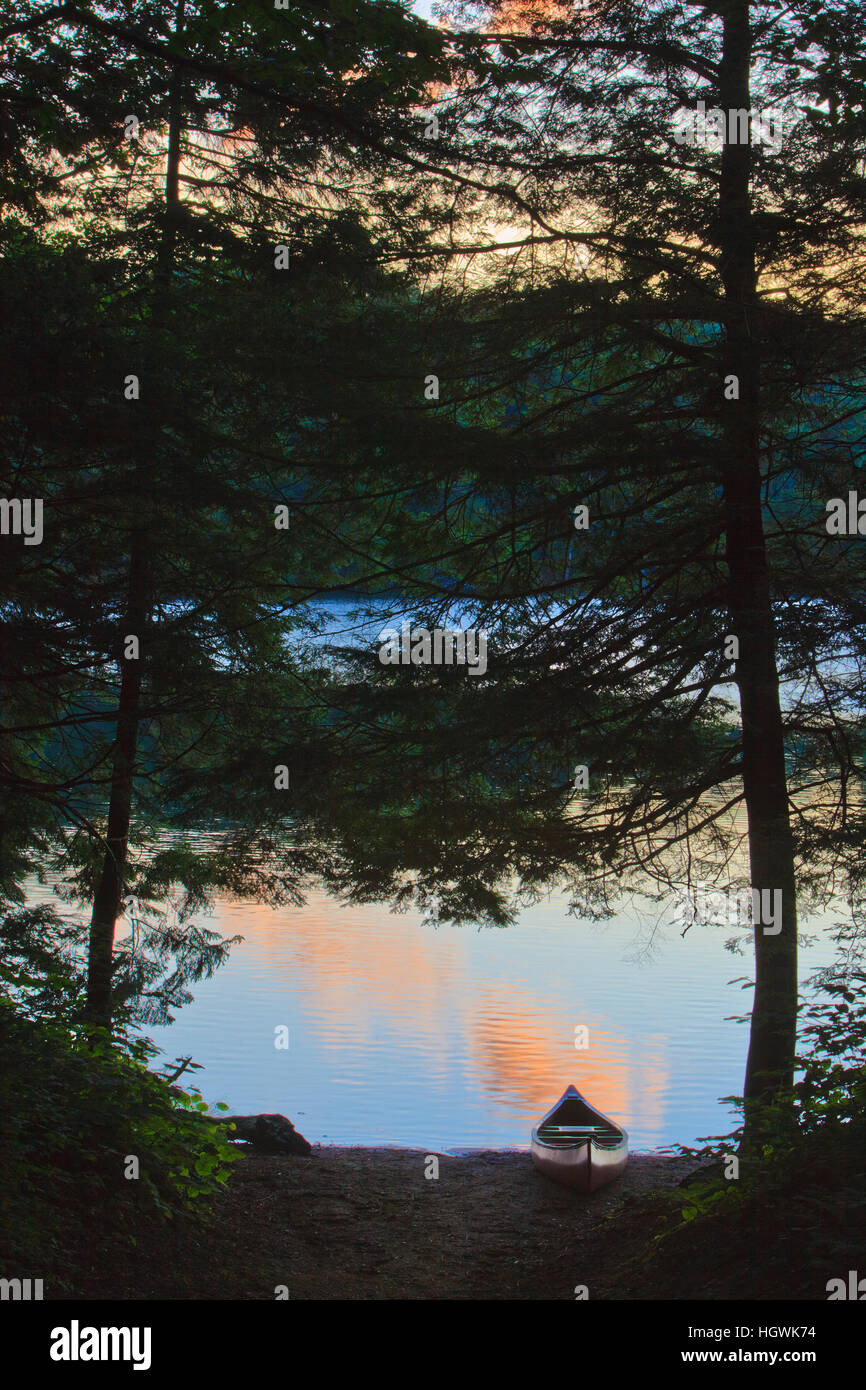 A canoe on the shore next to Zack Woods Pond in Hyde Park, Vermont ...