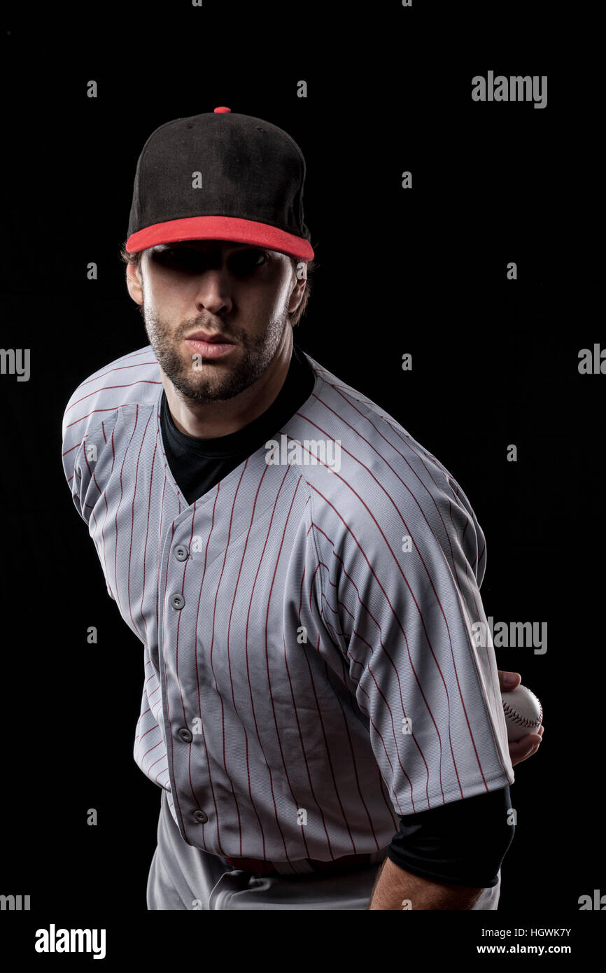 Baseball Player pitching a ball on a black background. Studio Shot ...