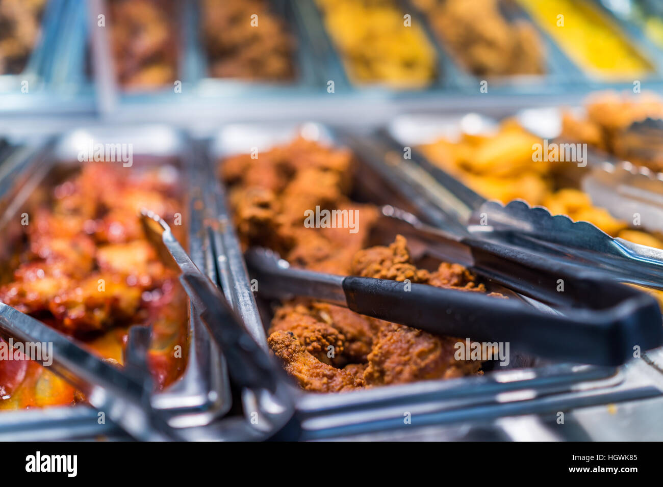 Fried chicken buffet bar self serve catering with tongs Stock Photo - Alamy