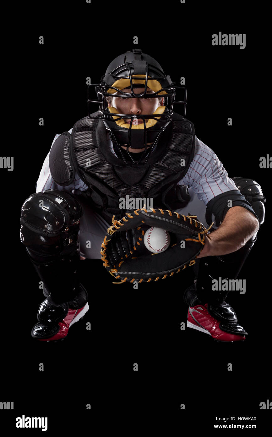 Baseball Player, catcher catching a ball, on a black background. Studio ...