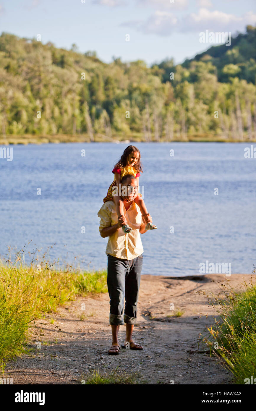 A man and his young daughter walk on a path to Mud Pond in Zack Woods ...