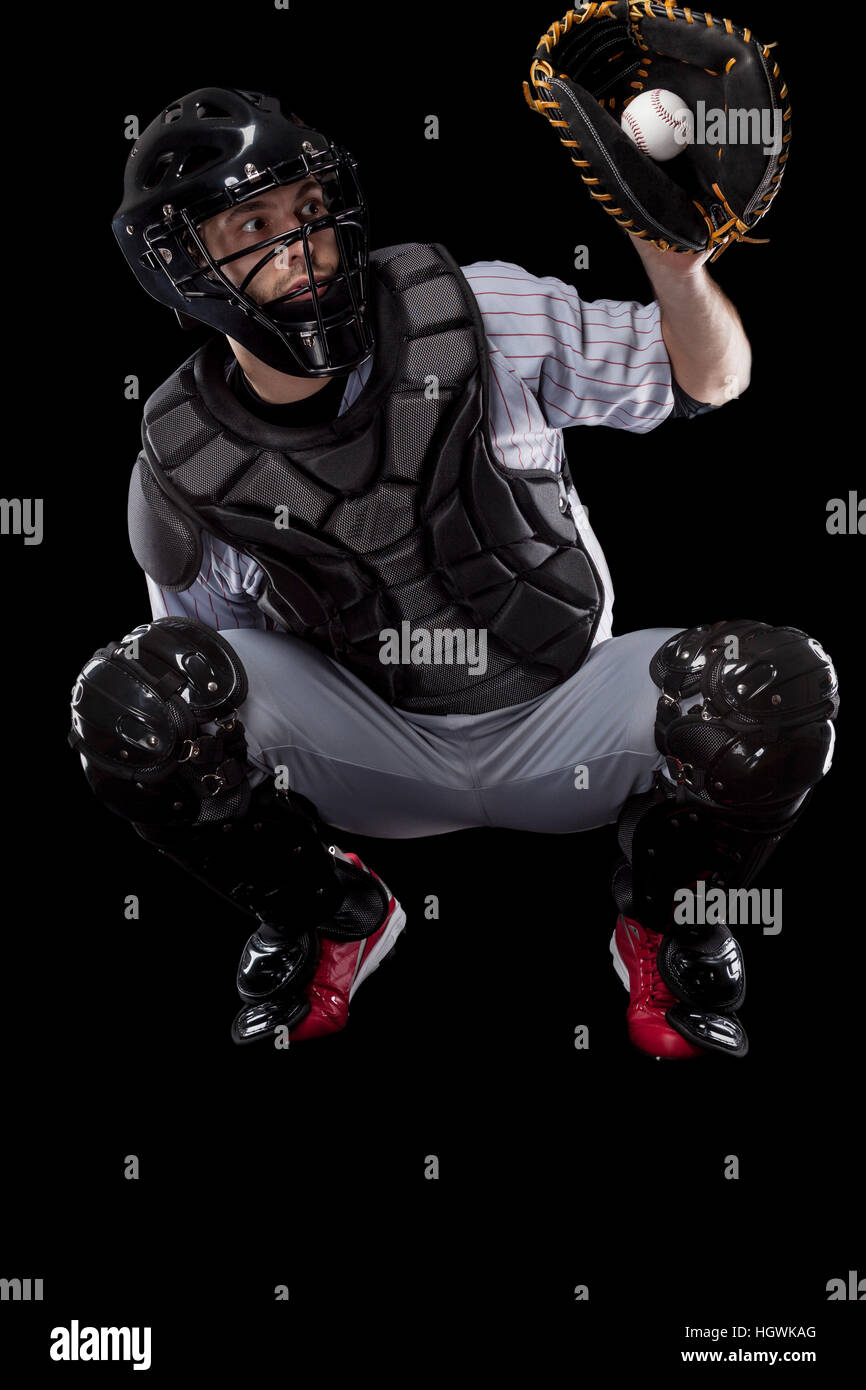 Baseball Player, catcher catching a wild pitch, on a black background ...